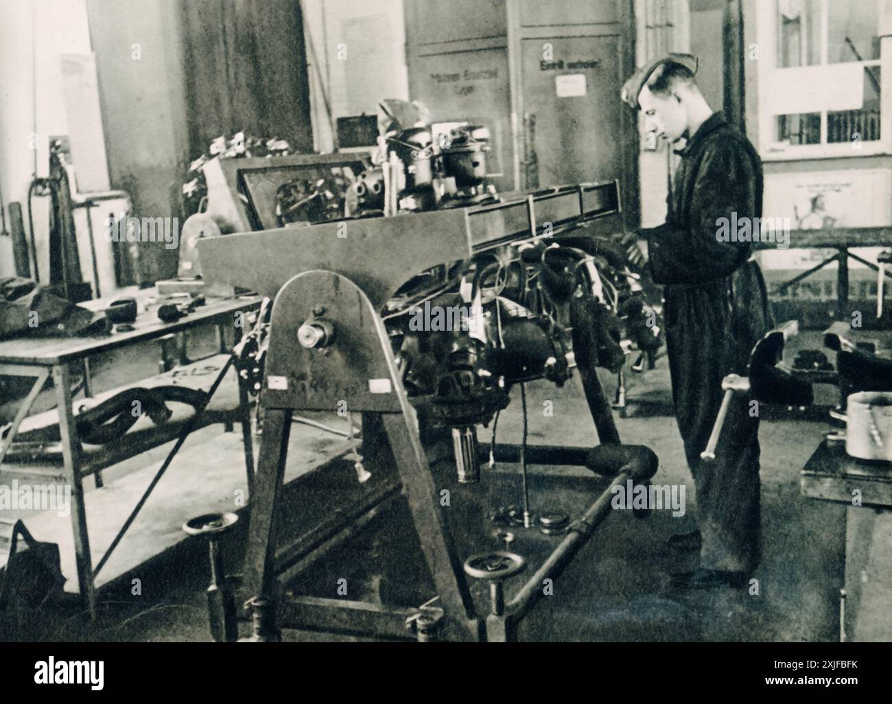 A photograph shows a soldier mounting part of a Junkers Ju 52 engine ...