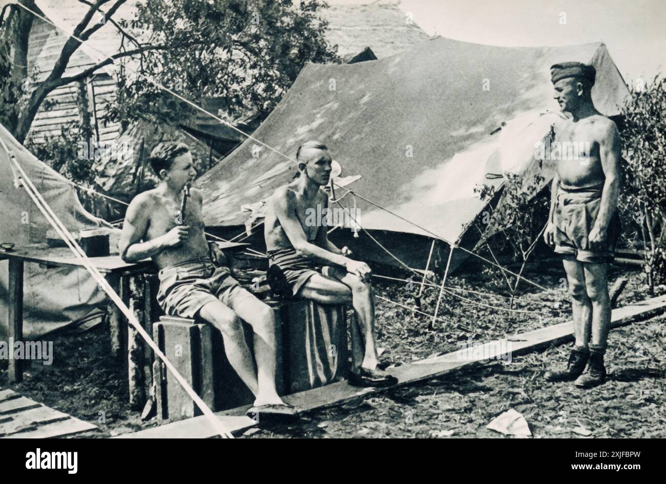 A photograph shows German soldiers sunbathing in the afternoon at a ...
