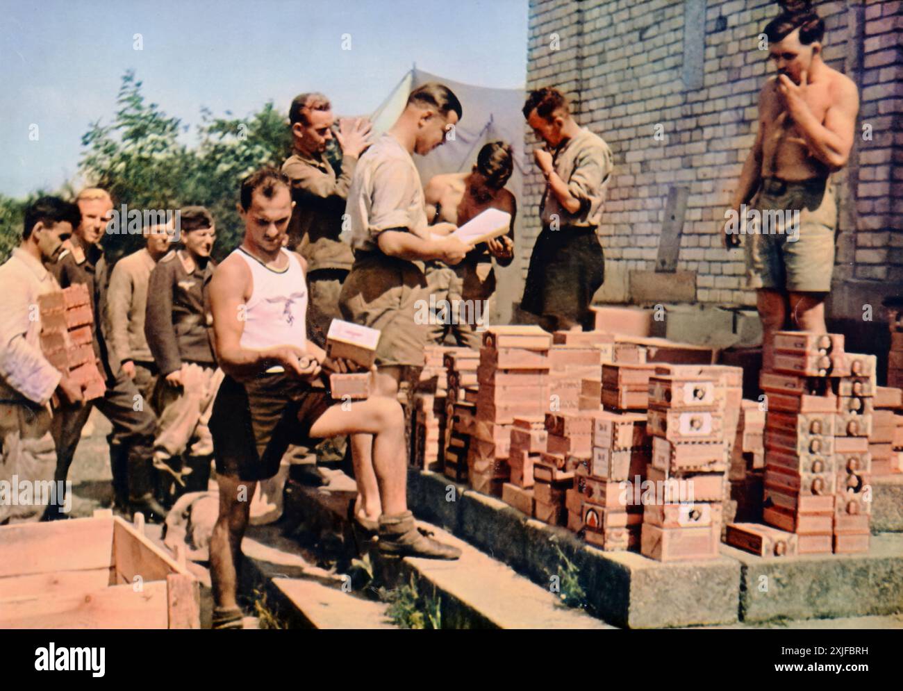 A color photograph shows German soldiers organizing and distributing ...