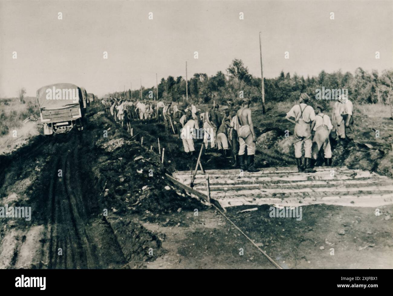 A photograph shows soldiers constructing corduroy roads—log roads laid ...