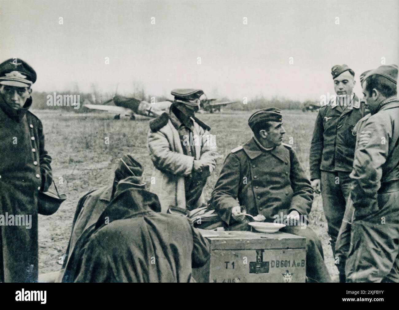 A photograph shows Spanish volunteer soldiers gathered at an airfield ...
