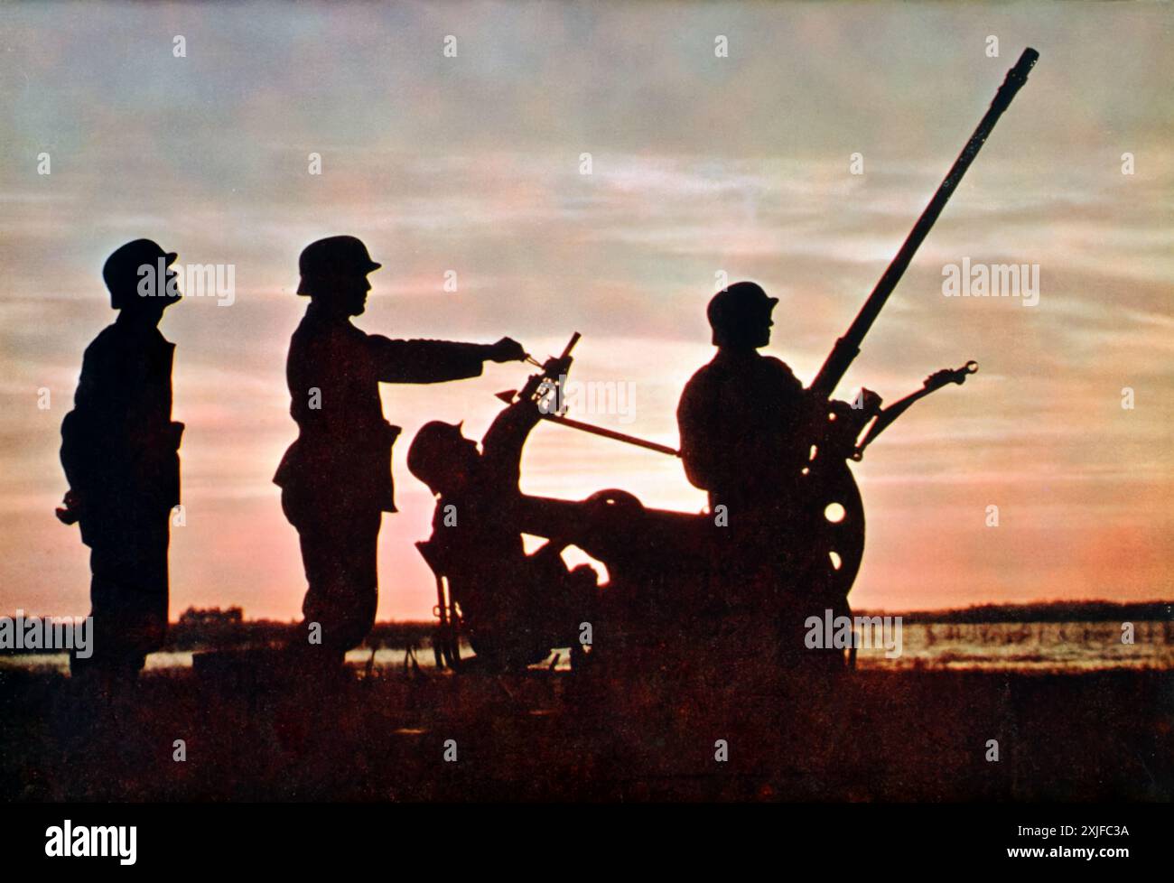 A photograph shows soldiers appearing as silhouettes against the low ...