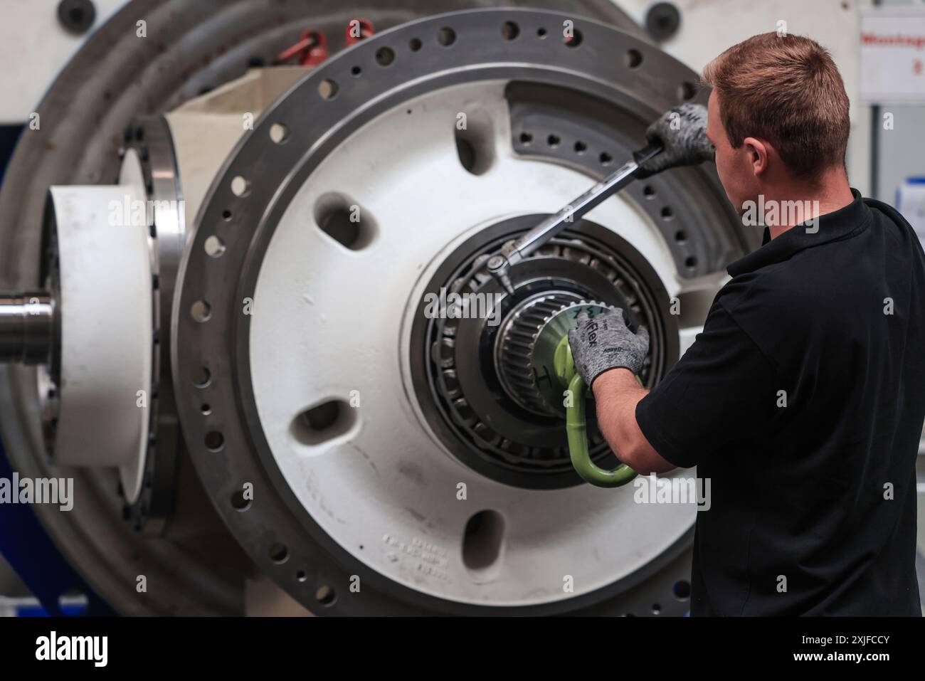 PRODUCTION - 18 June 2024, Rhineland-Palatinate, Dörth: An employee assembles gear components of ...