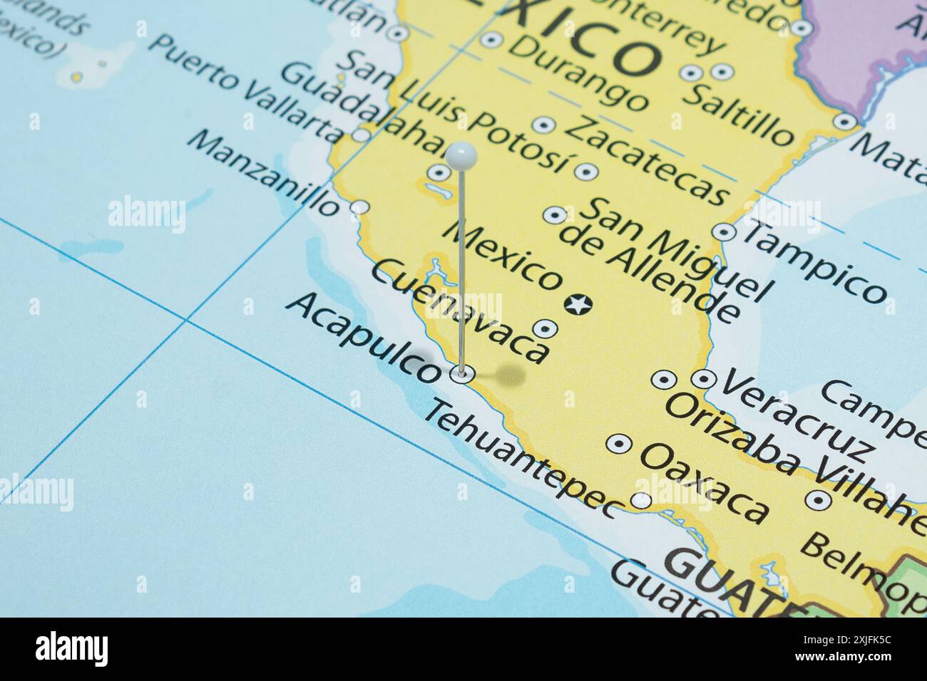 Close up to a Acapulco city with a white pin needle into Mexico country ...