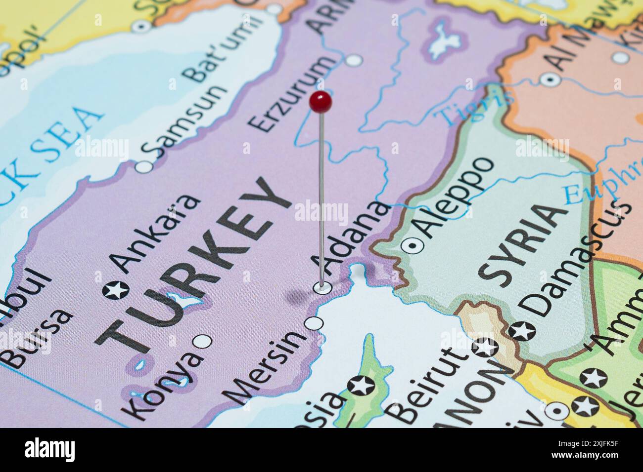 Close up to a Adana city with a red pin needle into Turkey country ...