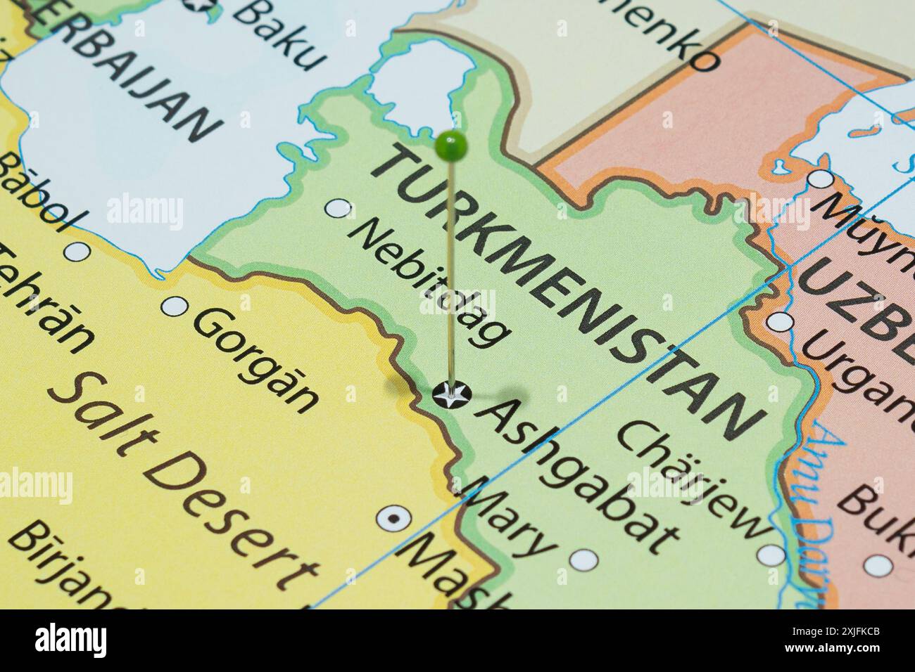 Close up to a Ashgabat city with a green pin needle into Turkmenistan ...