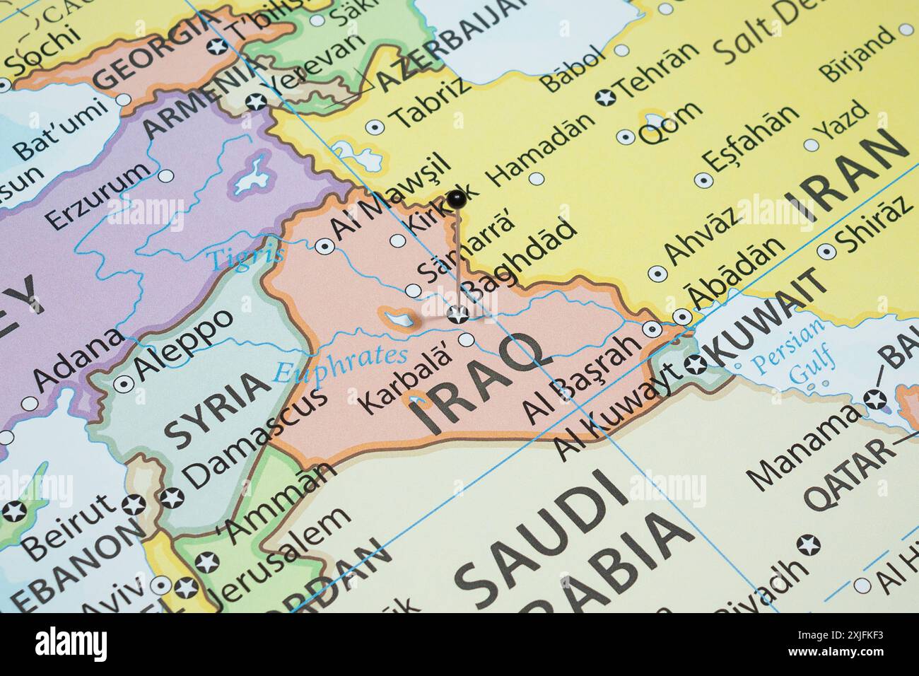 Close up to a Baghdad city with a black pin needle into Iraq country ...