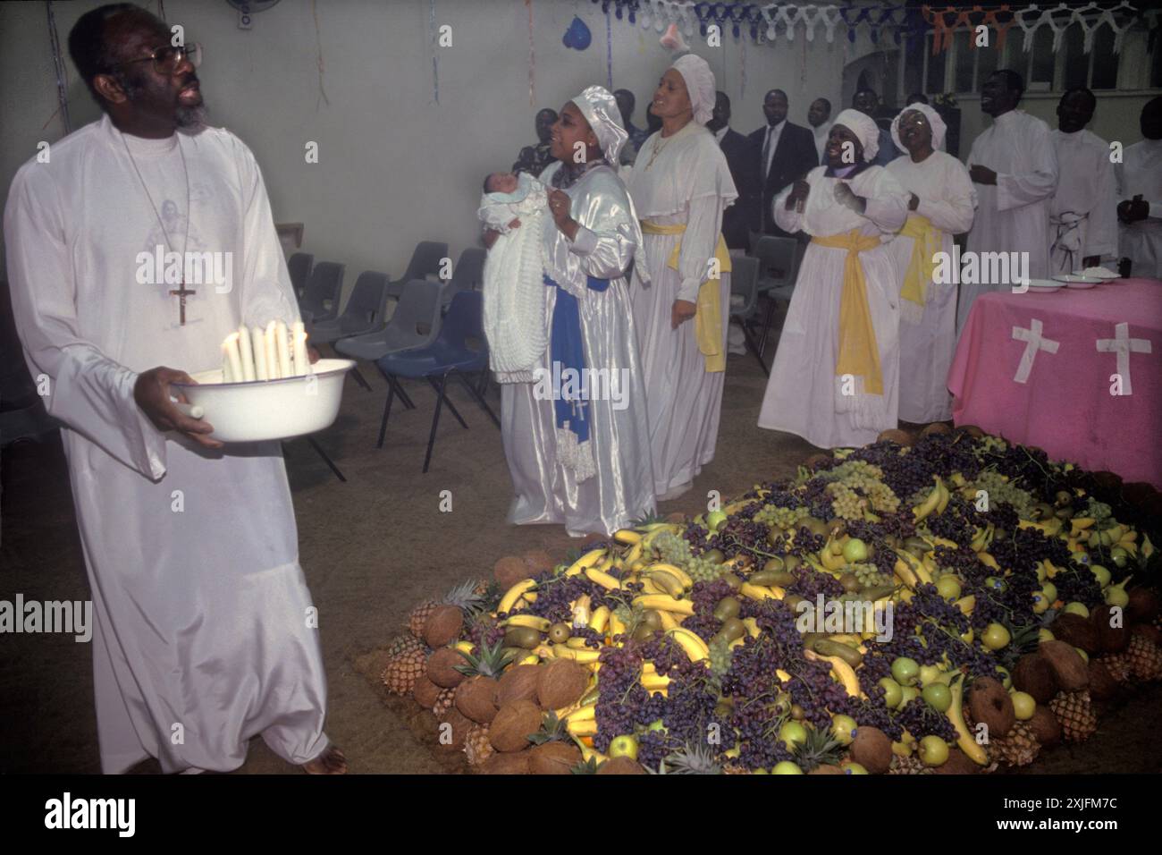 Christening - a baby naming ceremony, church members dance round the ...