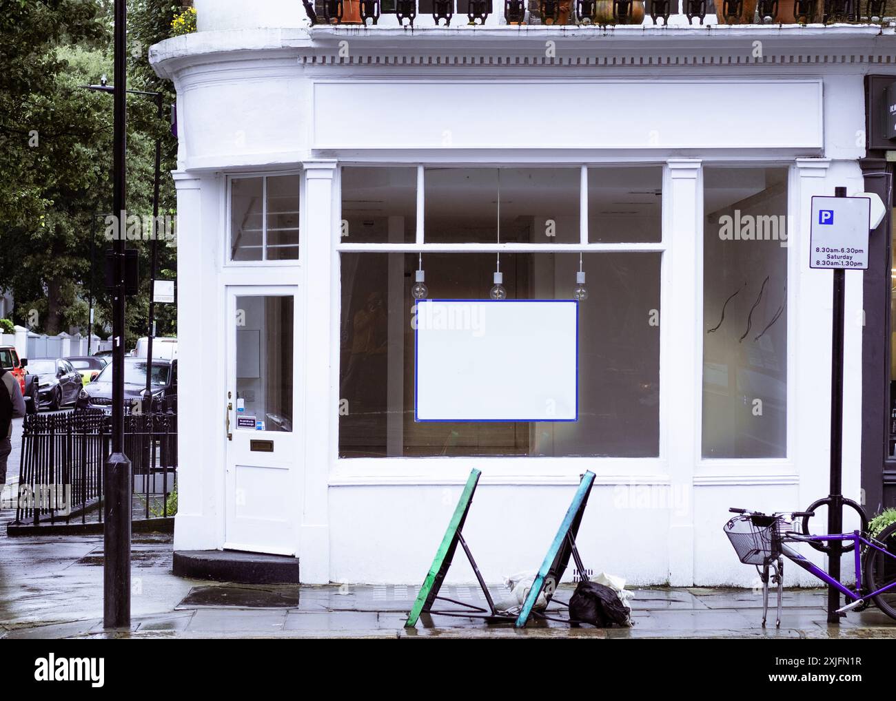 Empty vacant shop with blank sign in window with space for text copy ...