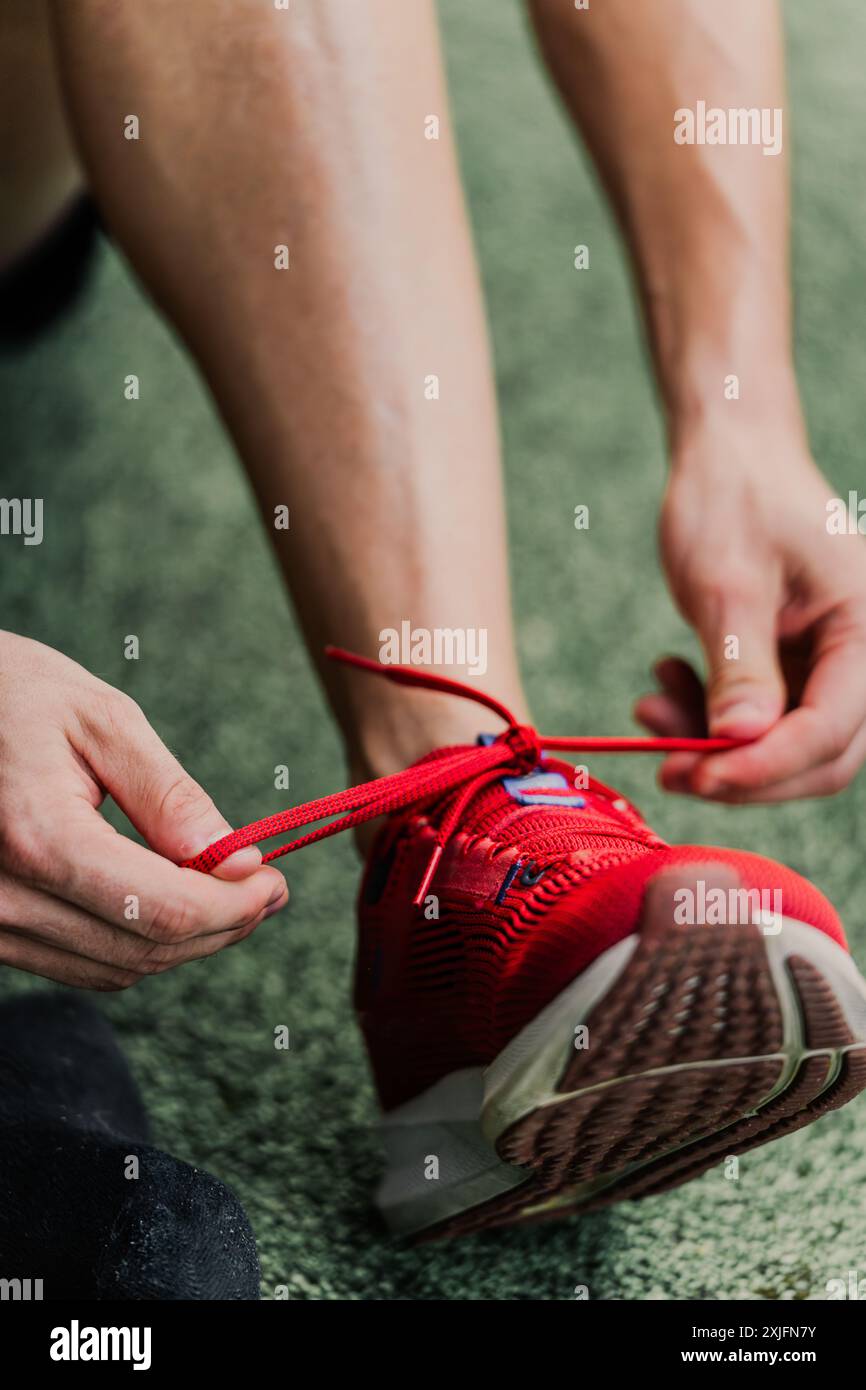 Runner athlete tying shoelaces going hi-res stock photography and ...
