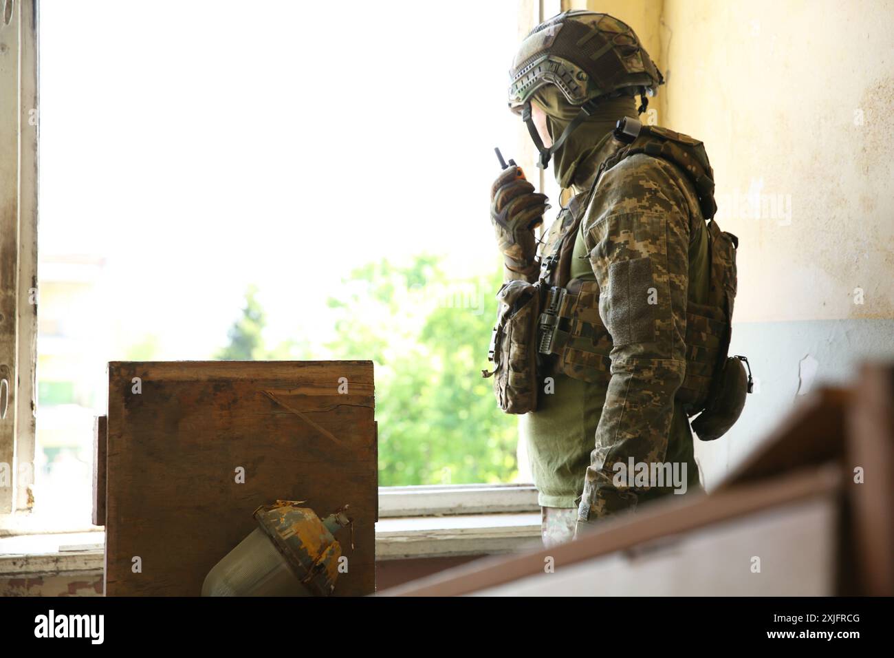 Military mission. Soldier in uniform with radio transmitter inside ...
