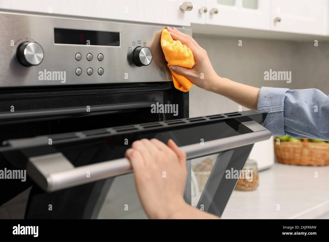 Woman cleaning electric oven with rag in kitchen, closeup Stock Photo ...