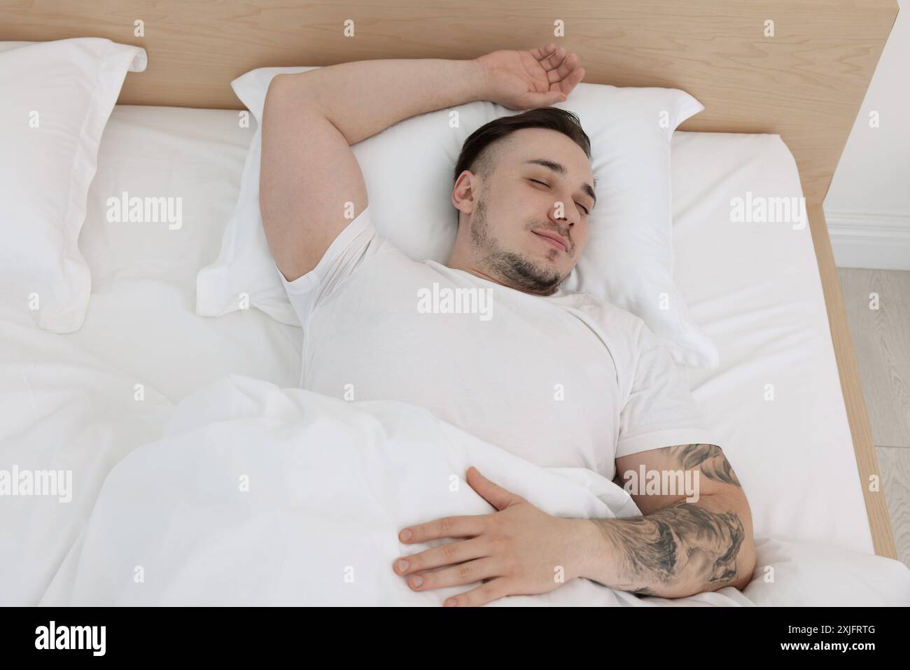 Bedtime. Handsome man sleeping in bed indoors, above view Stock Photo ...
