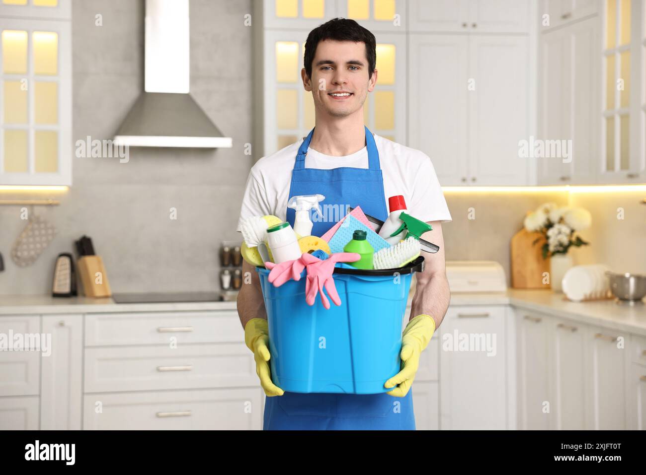 Man holding cleaning supplies hi-res stock photography and images - Alamy