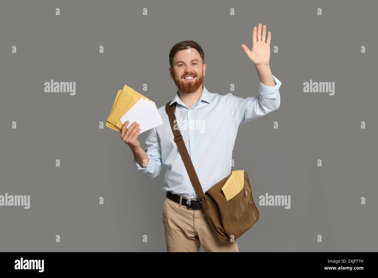 Postman with brown bag delivering letters on grey background Stock ...