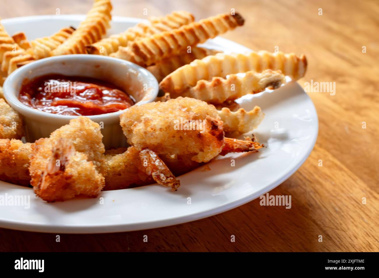 Deep fried shrimp and french fries cooked in an air fryer. Arranged in ...