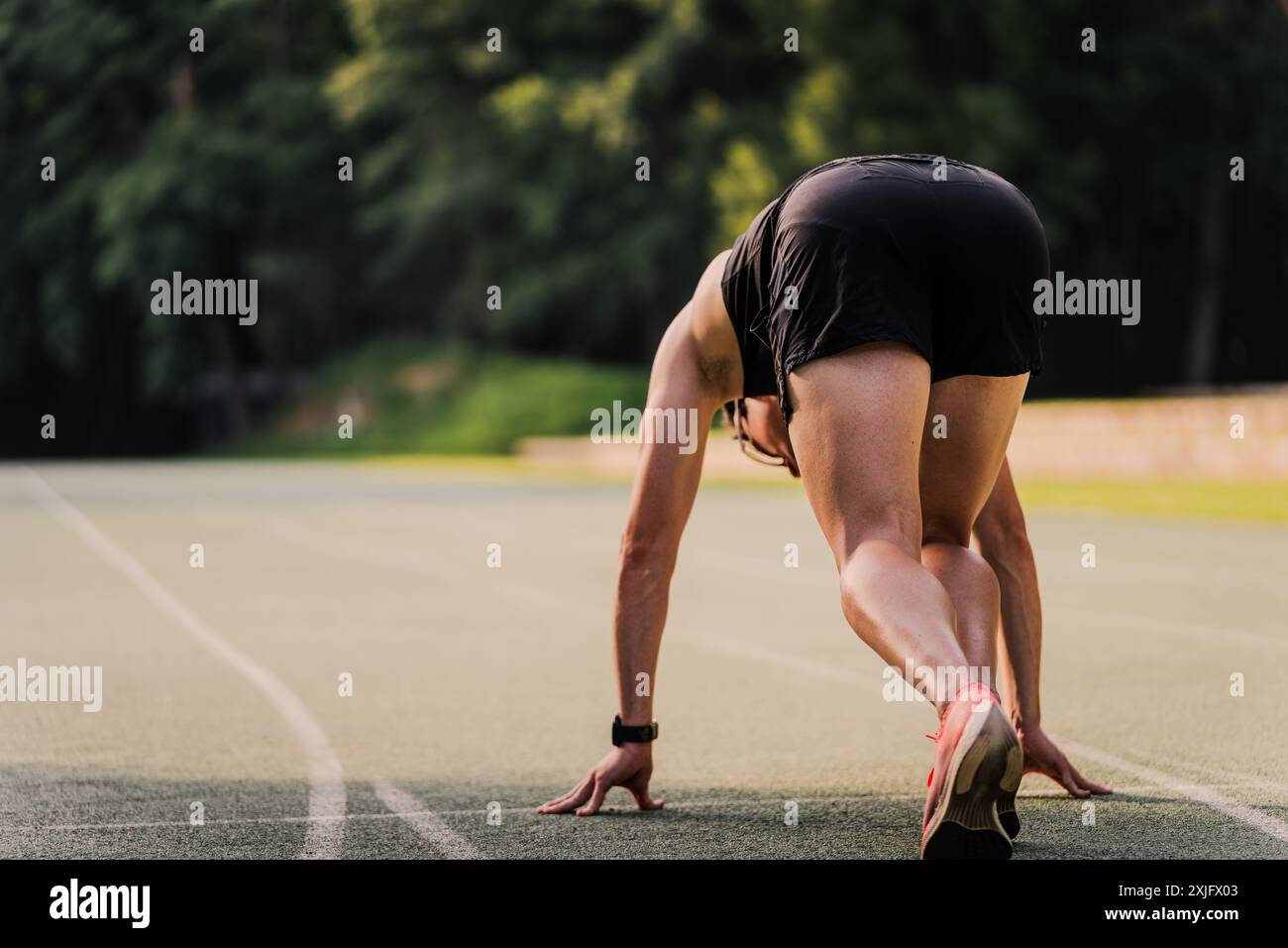 Track runner in starting position ready for the race. Copy space Stock ...