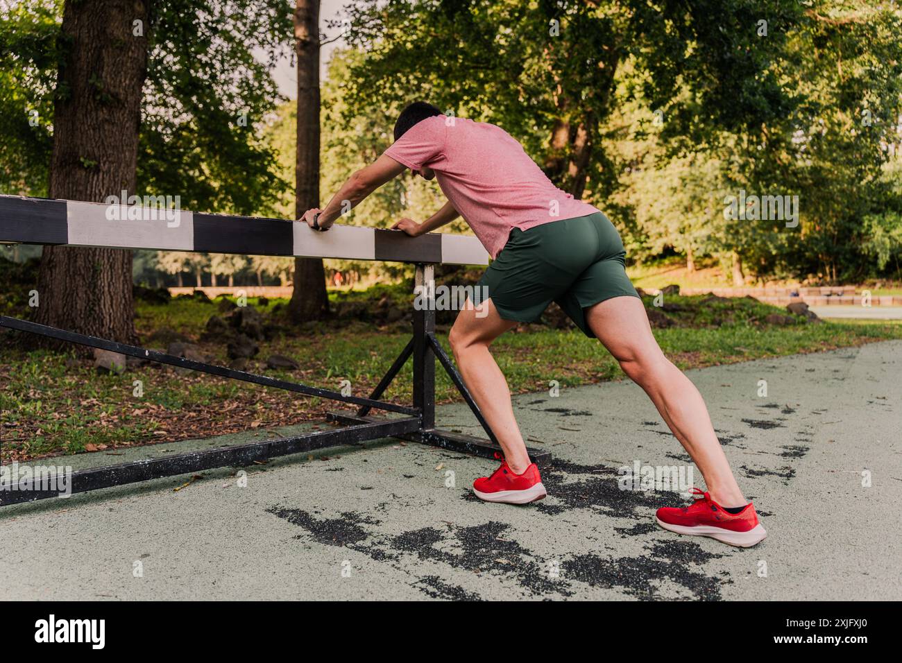 Runner stretching with the help of a strap after training Stock Photo ...