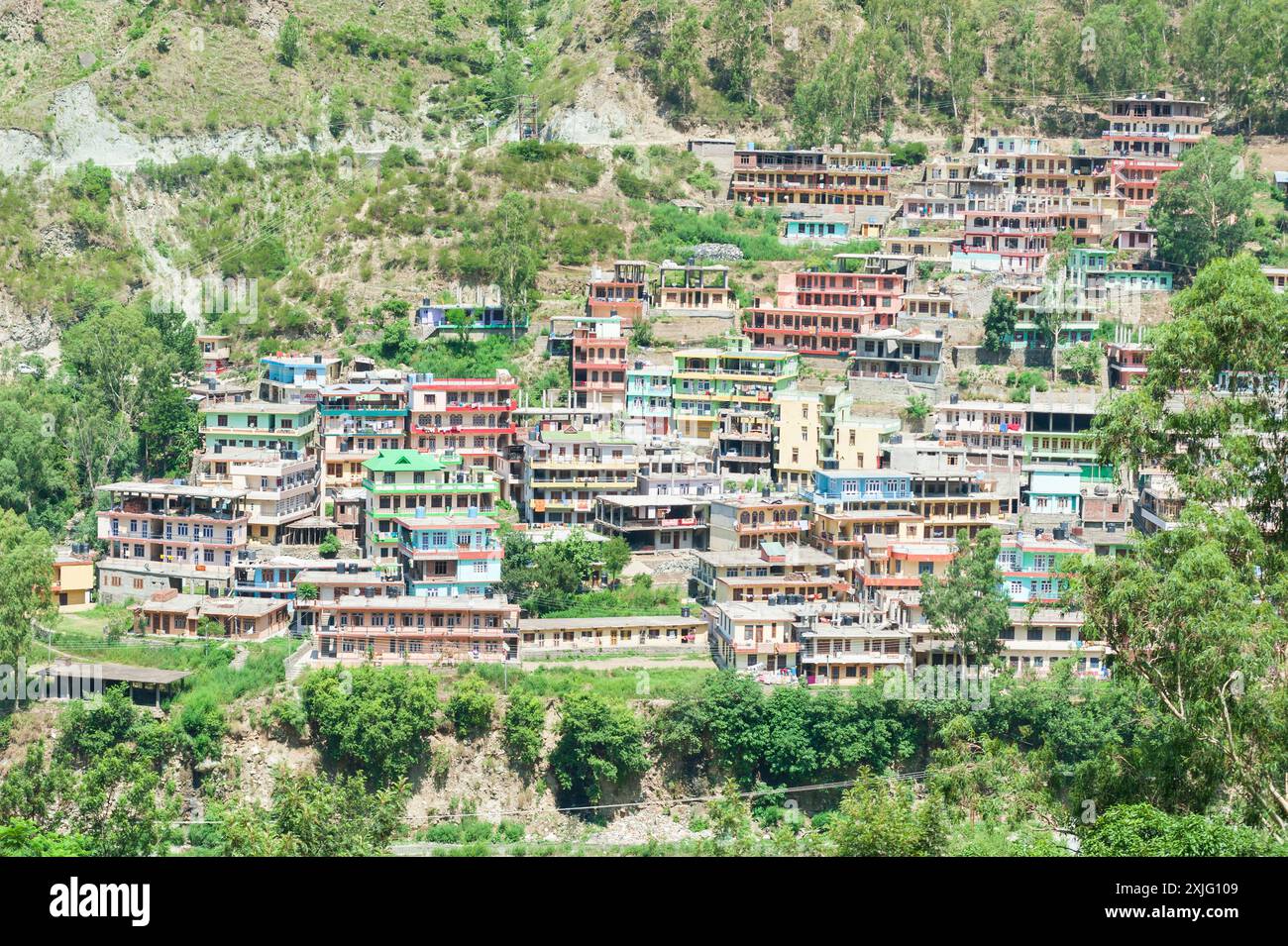 Colorful buildings nestled in the scenic, hilly landscapes of Himachal ...