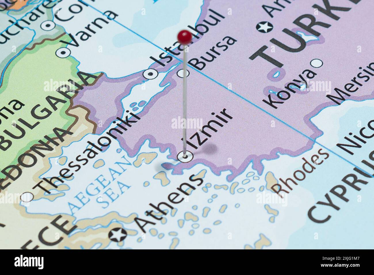 Close up to a Izmir city with a red pin needle into Turkey country ...