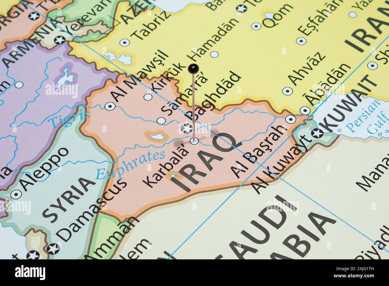 Close up to a Karbala city with a black pin needle into Iraq country ...