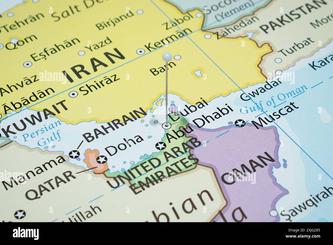 Close up to a Dubai city with a white pin needle into United Arab ...