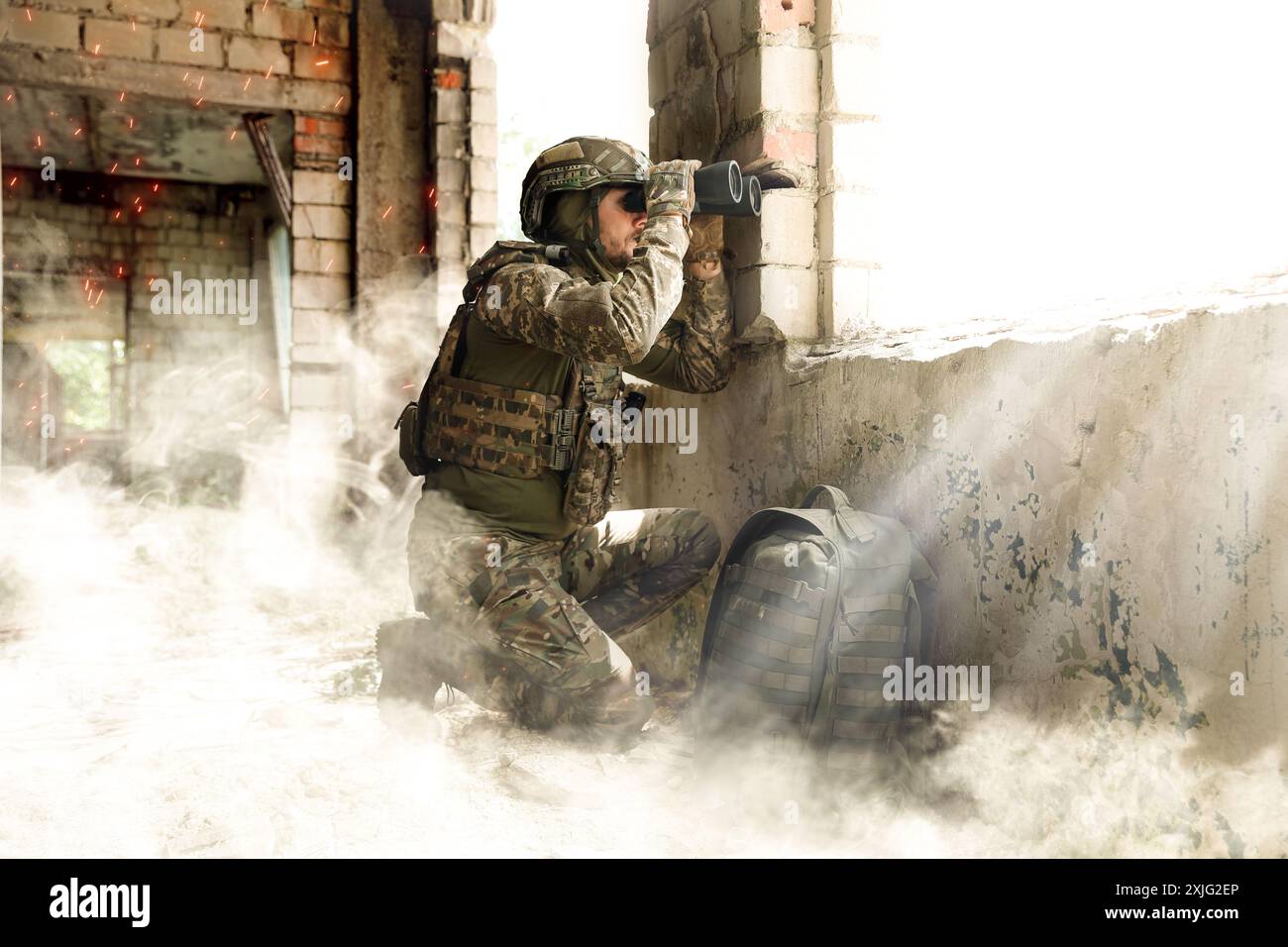 Soldier using binoculars in building during military operation Stock ...