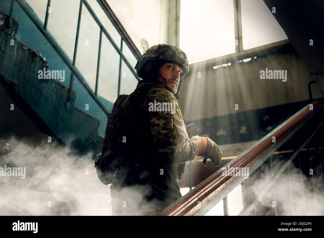 Soldier going upstairs inside building during military operation Stock ...