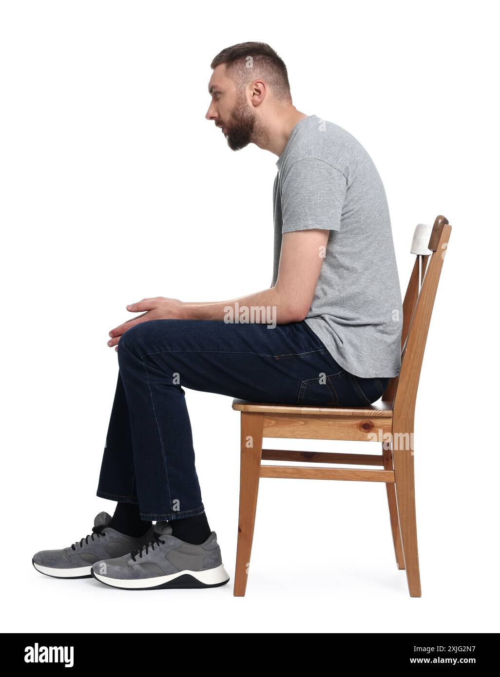 Man with poor posture sitting on chair against white background Stock ...