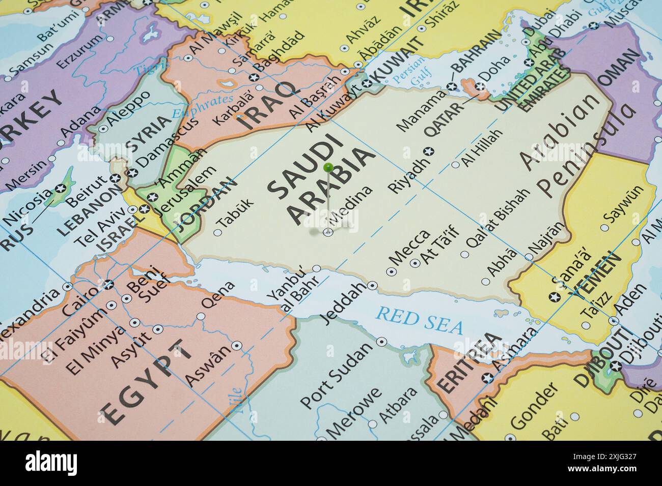 Close up to a Medinah city with a green pin needle into Saudi Arabia ...