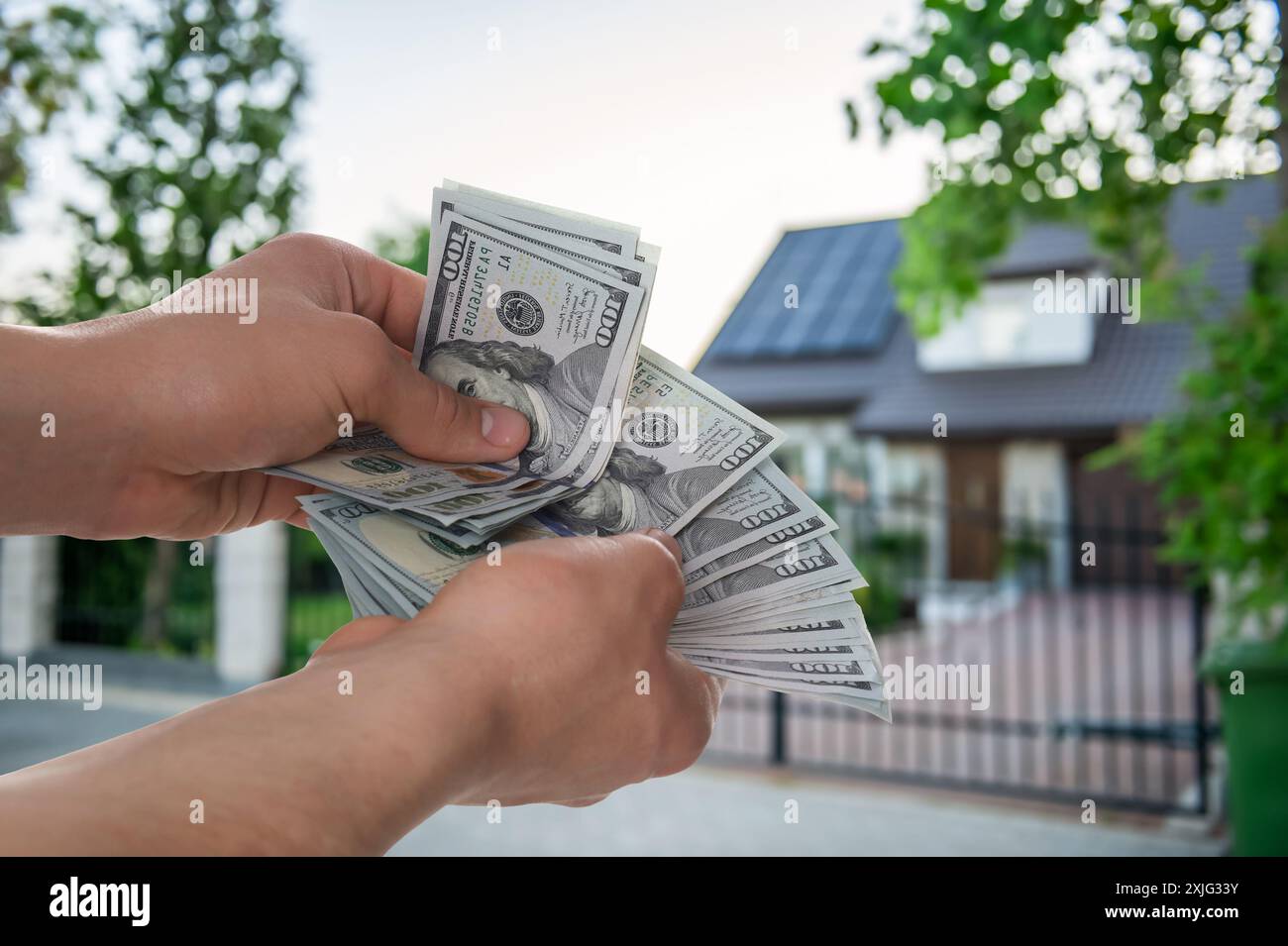 Man counting money against beautiful house, closeup. Real estate ...