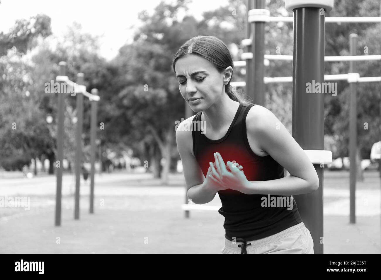 Heart attack. Woman suffering from pain and pressing hands to chest at ...