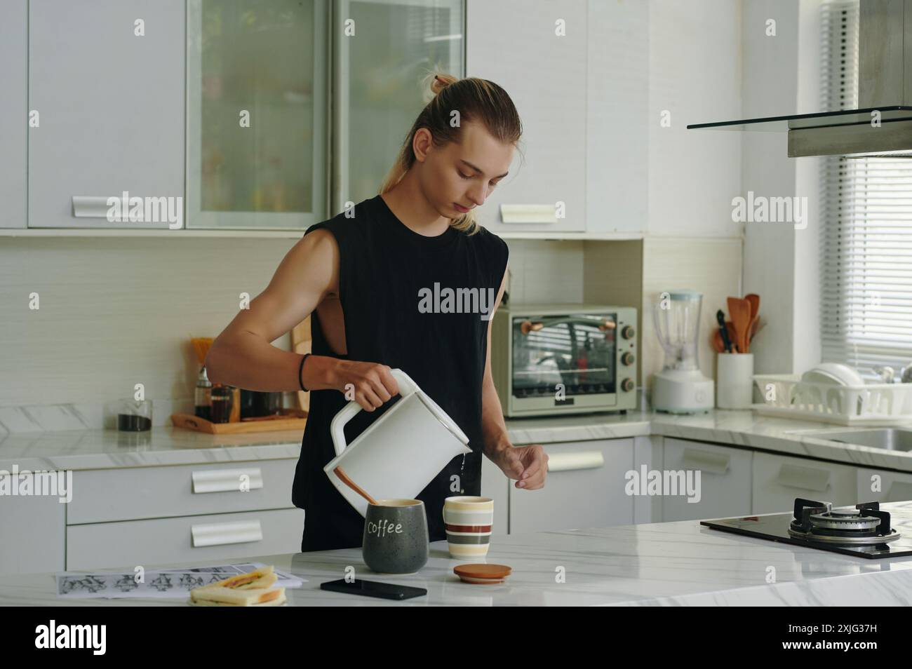 Model Making Coffee In The Kitchen Stock Photo - Alamy