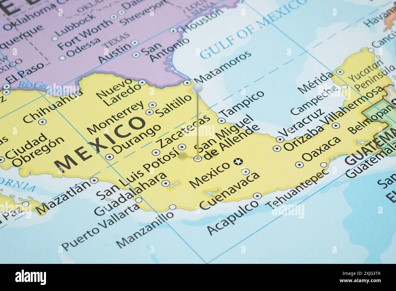 Close up to a San Miguel de Allende city with a white pin needle into ...