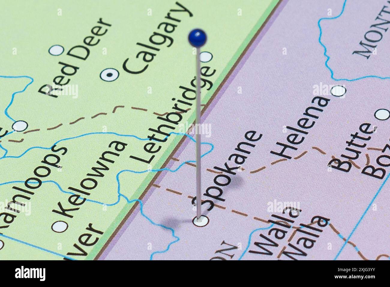 Close up to a Spokane city with a blue pin needle into United States of ...