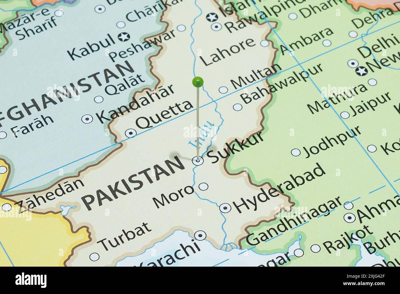 Close up to a Sukkur city with a green pin needle into Pakistan country ...
