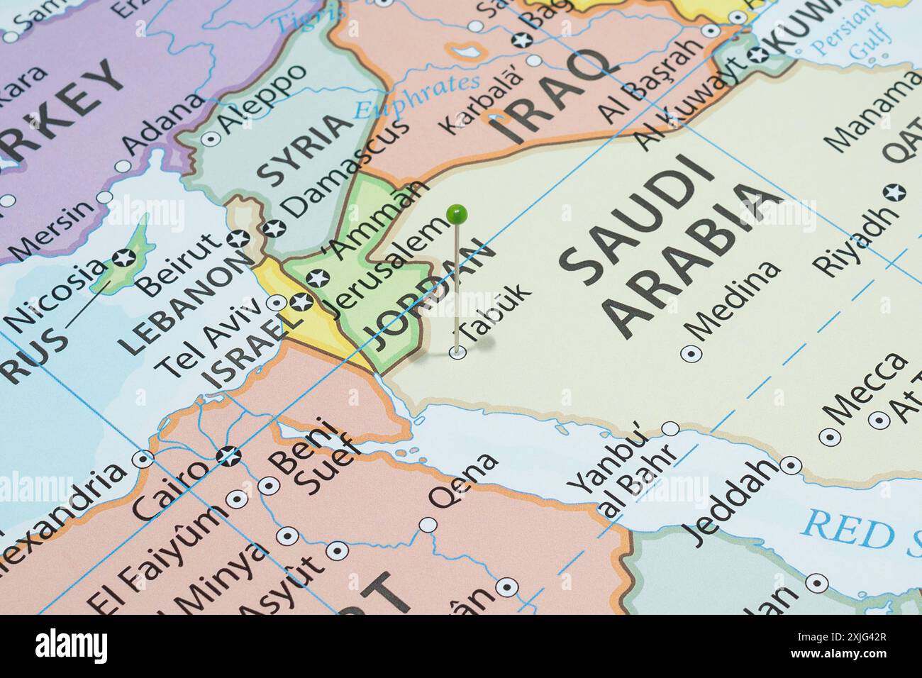 Close up to a Tabuk city with a green pin needle into Saudi Arabia ...