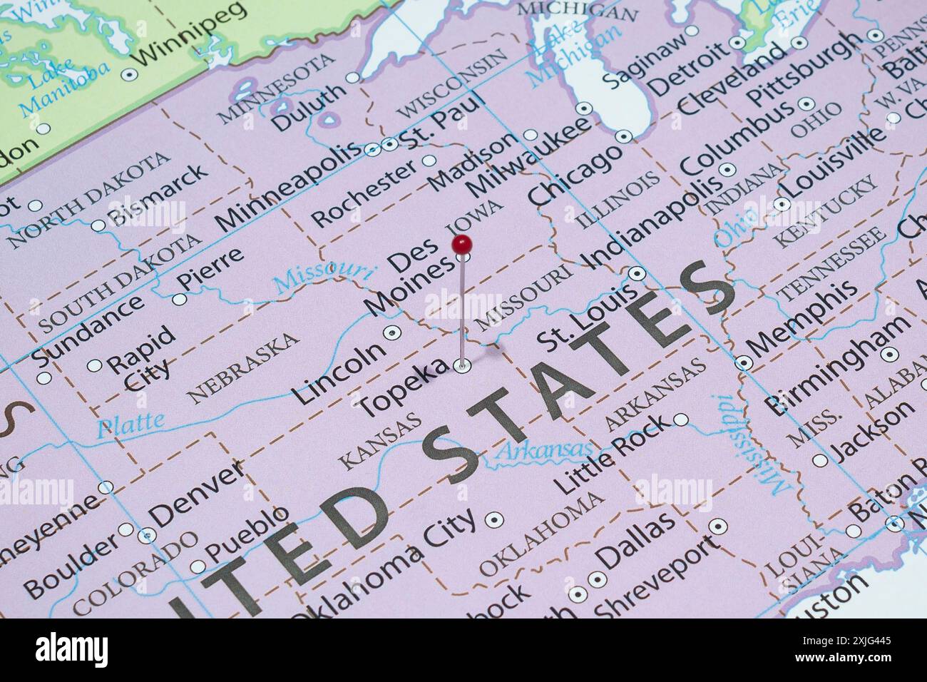 Close up to a Topeka city with a red pin needle into United States of ...