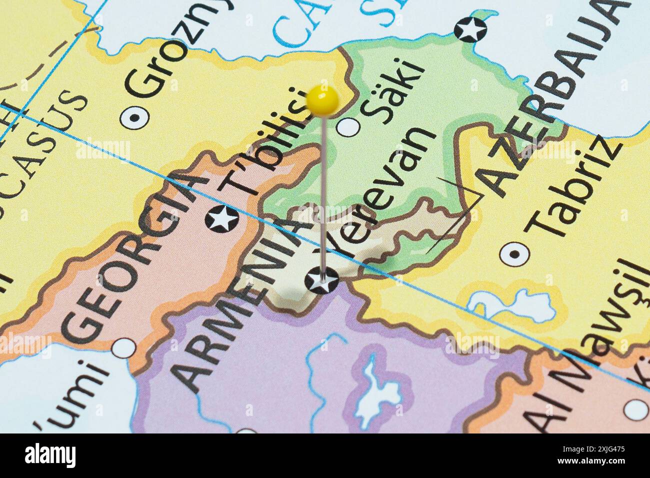 Close up to a Yerevan city with a yellow pin needle into Armenia ...