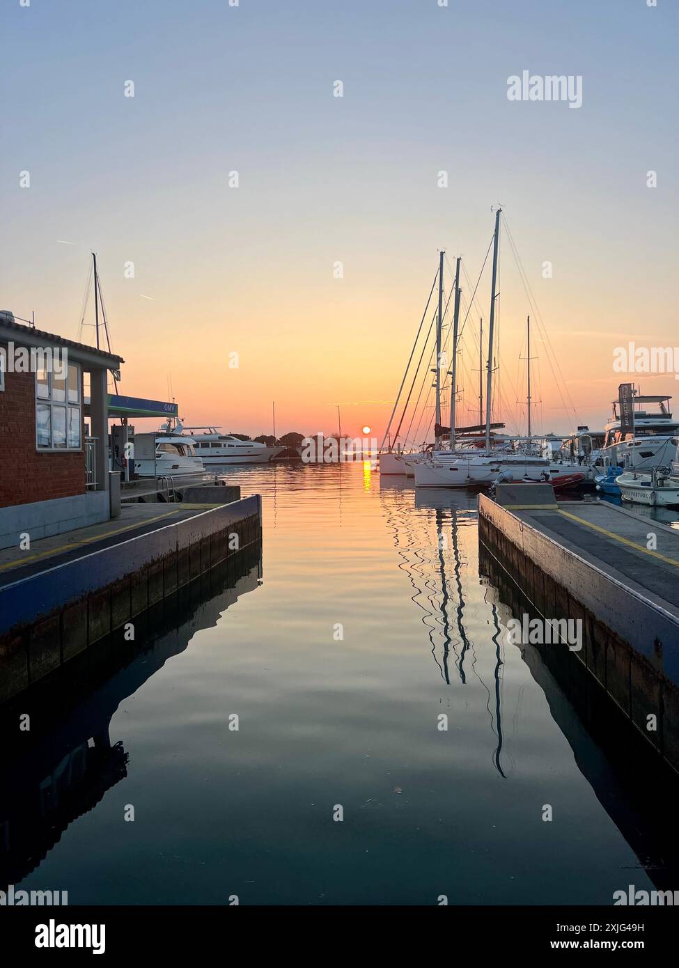 sunset at a beautiful harbor with sailing yachts Stock Photo - Alamy