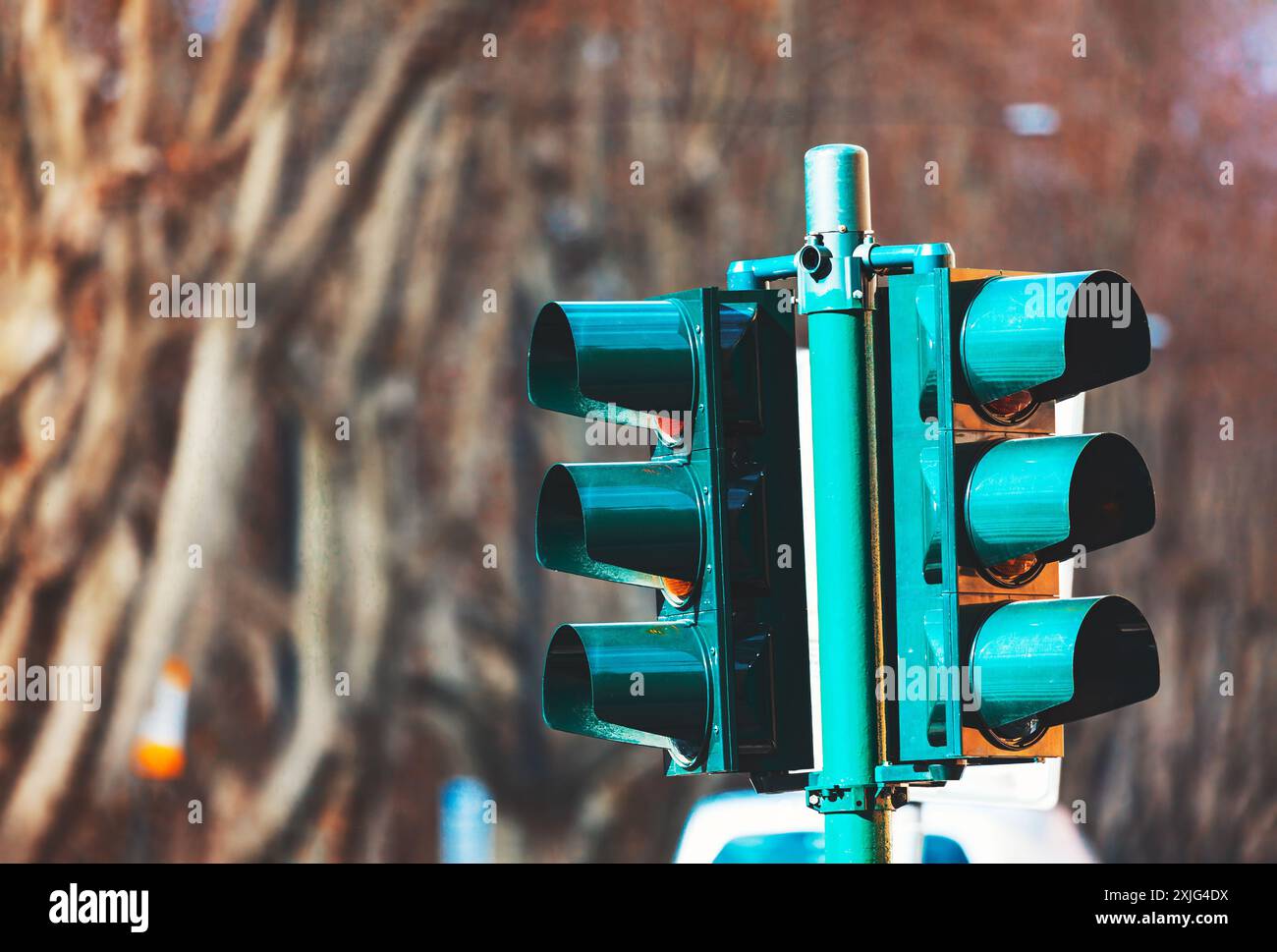 Traffic light is on a pole in the city. Traffic signal is mounted on a ...