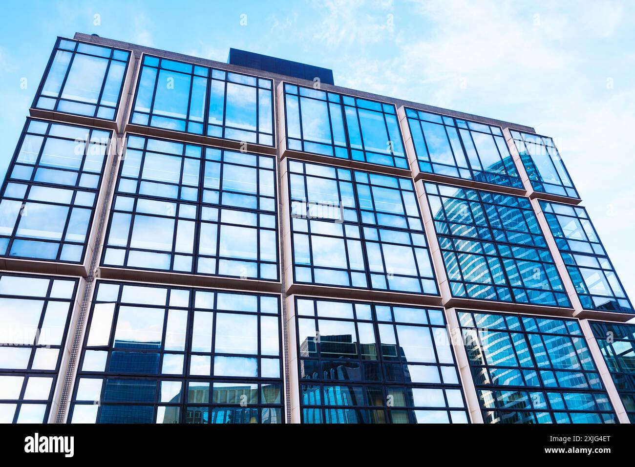 Skyscraper with numerous windows under a clear blue sky. Reflective ...