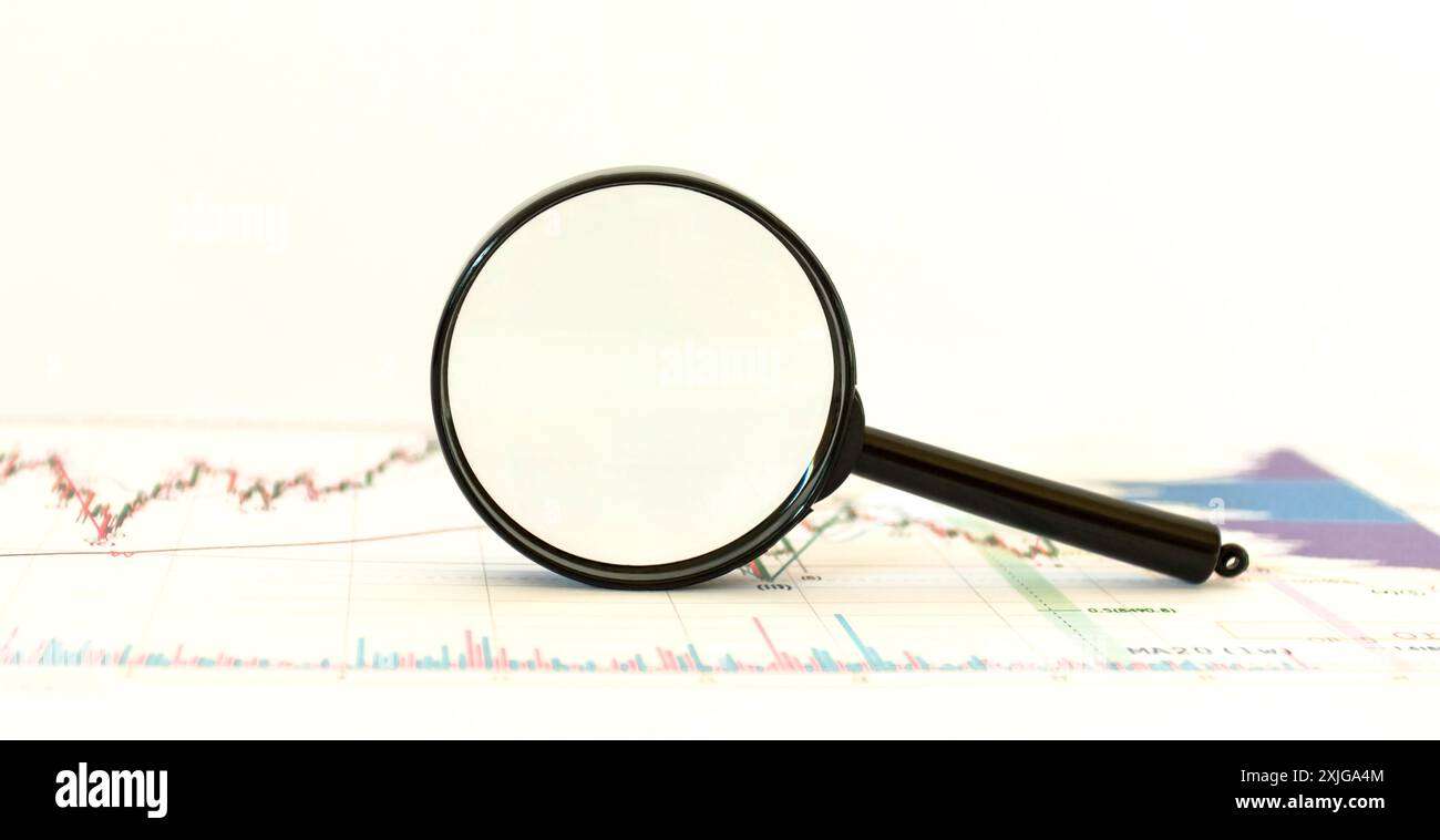 Magnifying Glass on on background with charts. Business Concept. Front ...