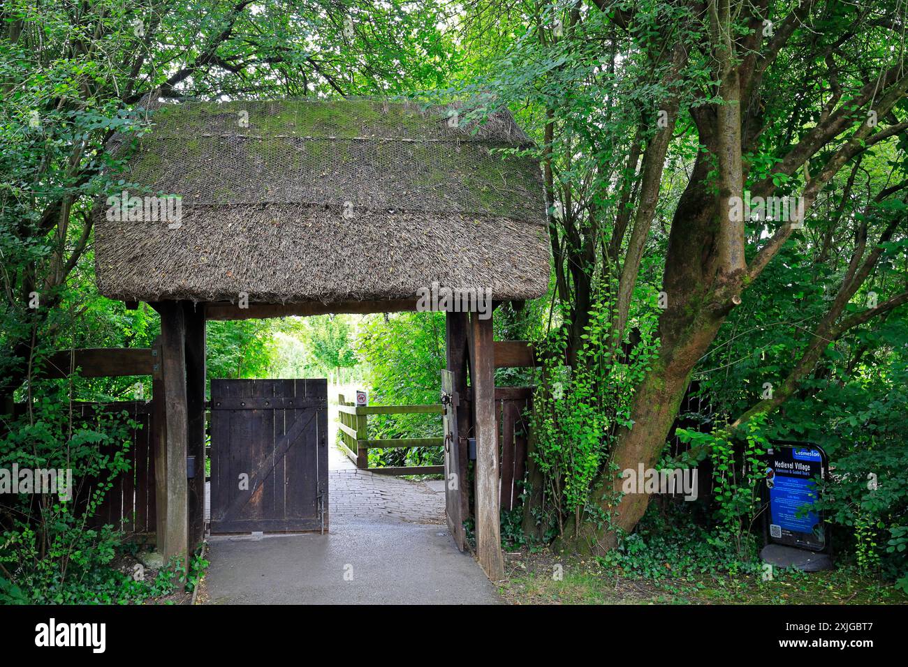 Entrance gate with thatched roof at the Mediaeval village, Cosmeston ...