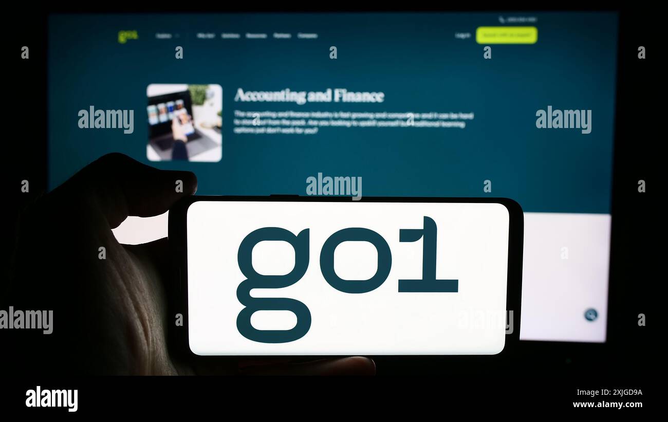 Person holding cellphone with logo of Australian online education ...
