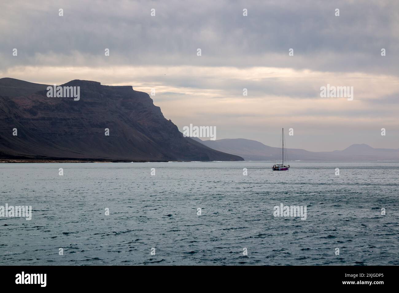 View from a boat on the volcanic cliffs and rocks in the north of the ...