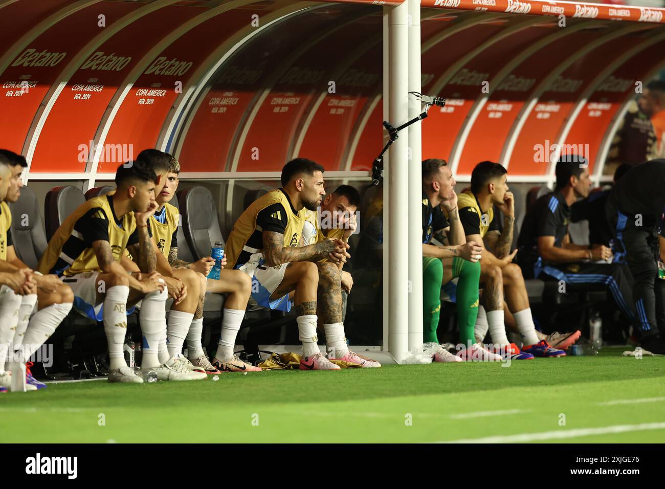 Argentine forward Lionel Messi (C) reacts while sitting on the bench ...