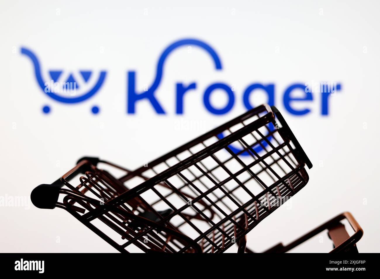 In this photo illustration, a shopping cart is seen in front of the ...