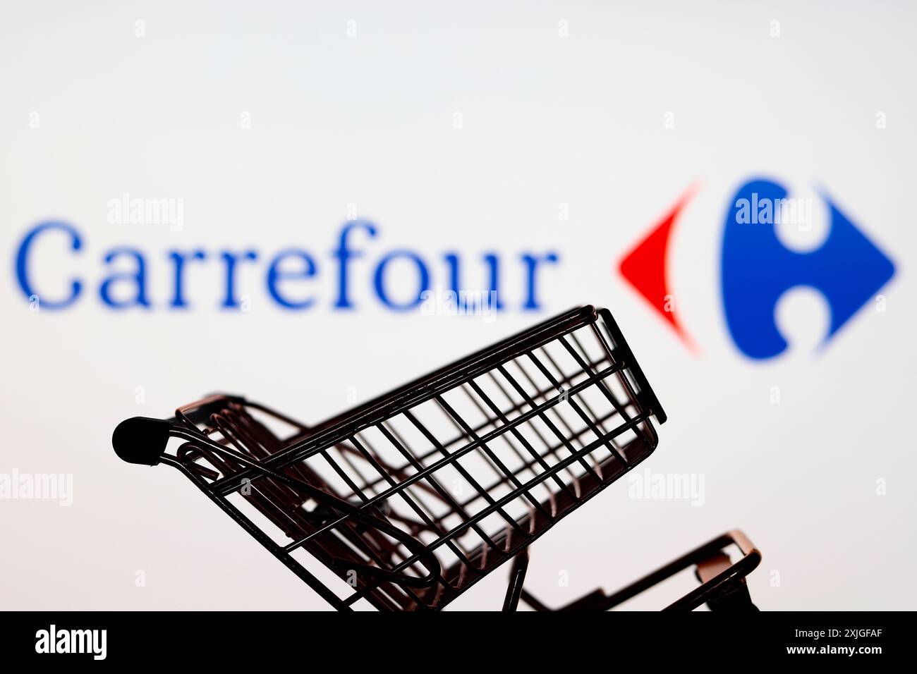 In this photo illustration, a shopping cart is seen in front of the ...
