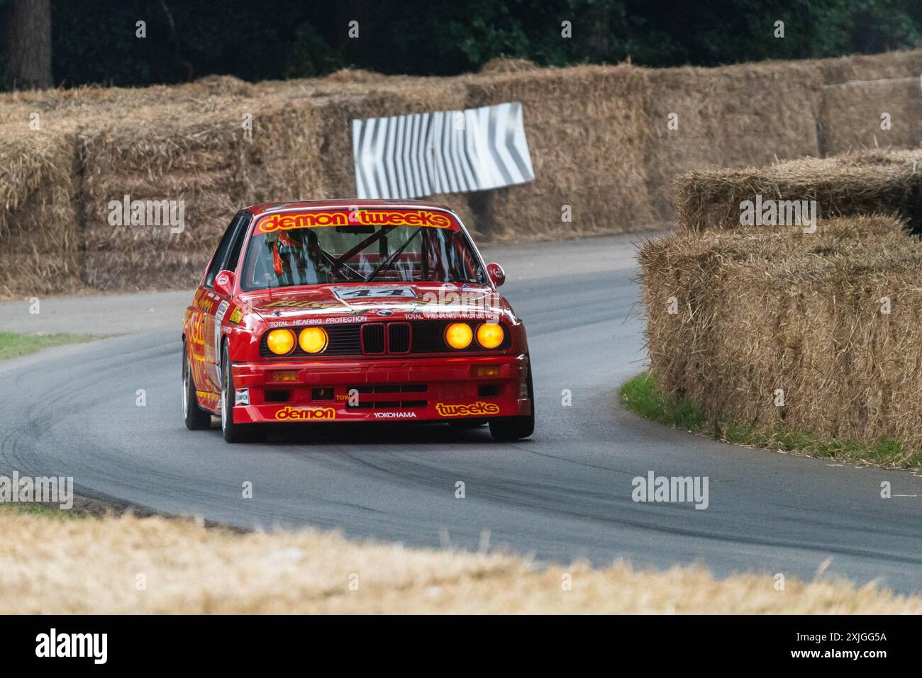 1987 BMW E30 M3 race car driving up the hill climb track at the ...